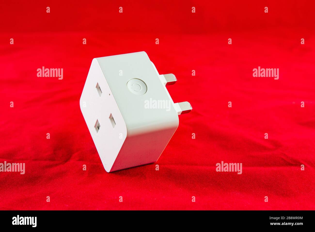 WiFi Smart Power Socket of White color on a red background. Interned of ...