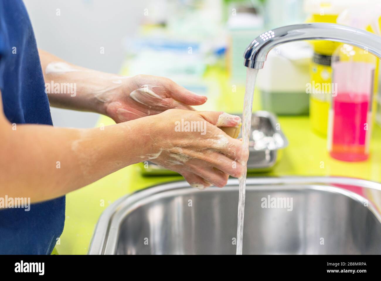 Coronavirus prevention. Close up unrecognizable nurse washing her hands ...
