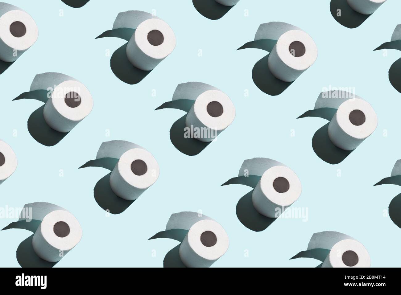 Toilet paper with a stiff shadow on a light background. A concept on ...