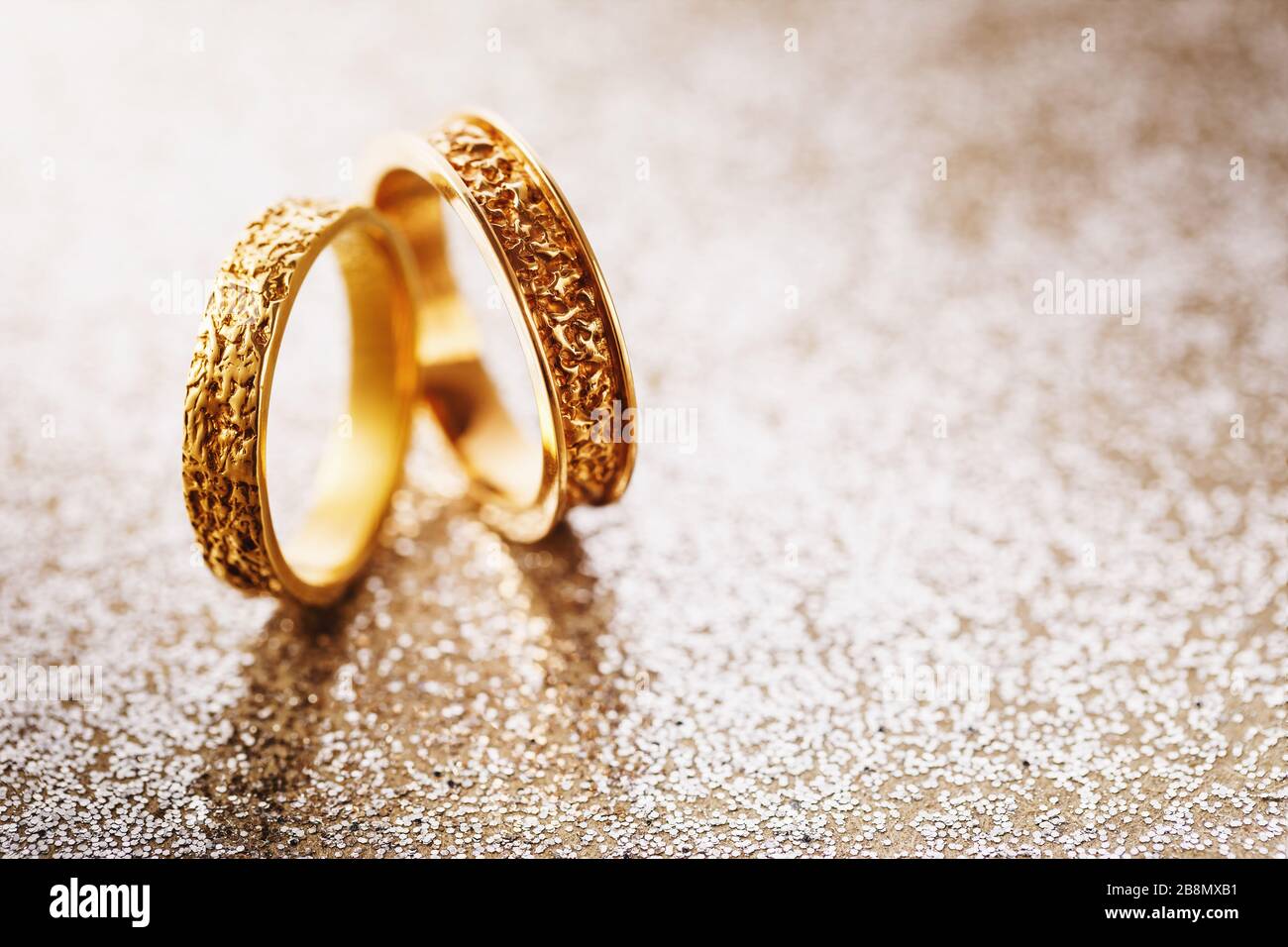 Two wedding rings on a brilliant background with a copy of space Stock ...