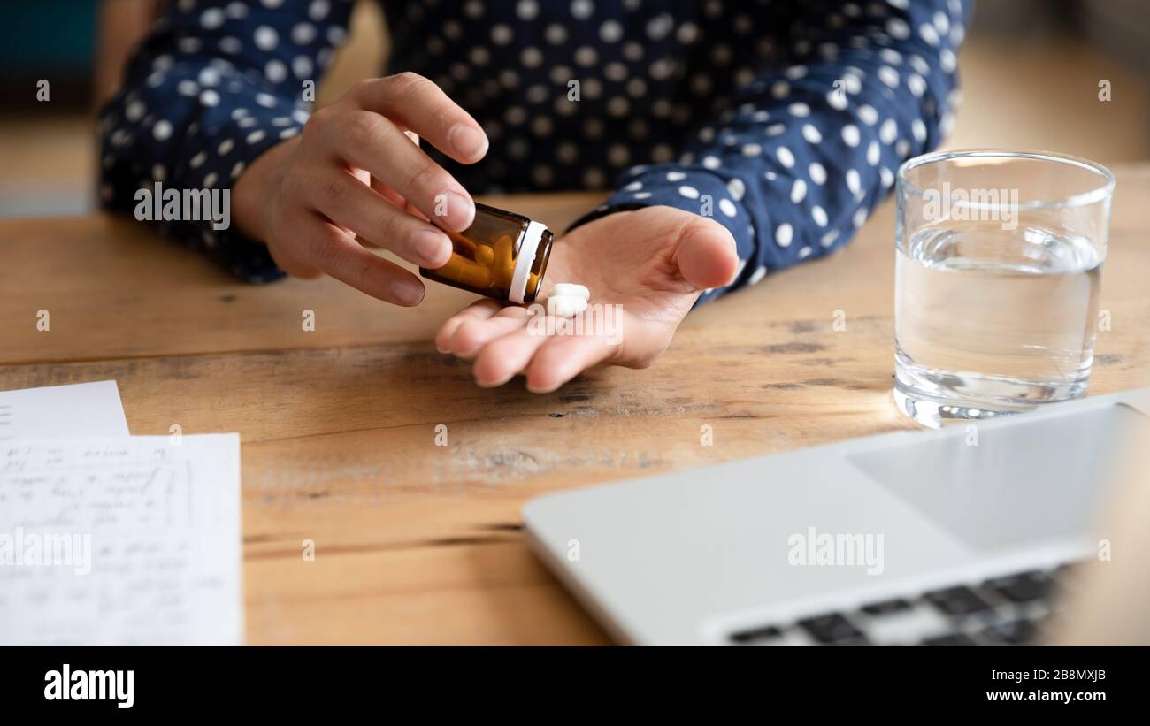 Close up young Indian woman taking out pills from bottle Stock Photo ...