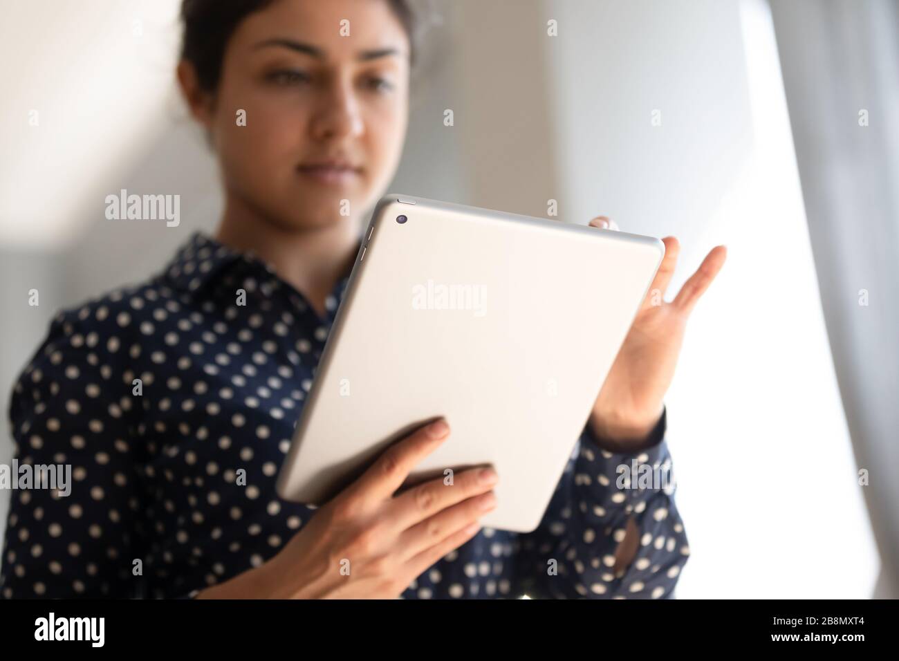 Close up focused Indian woman using computer tablet Stock Photo - Alamy