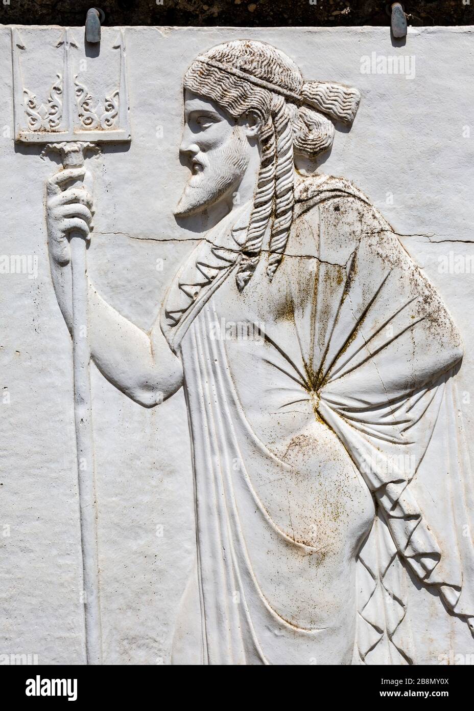 Carving of an ancient man with a trident in the Roman City of ...
