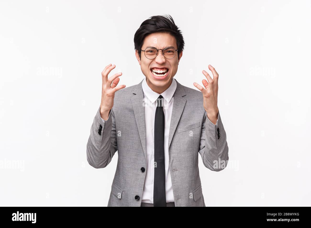 Waist-up portrait of hateful, outraged aggressive asian man in grey ...