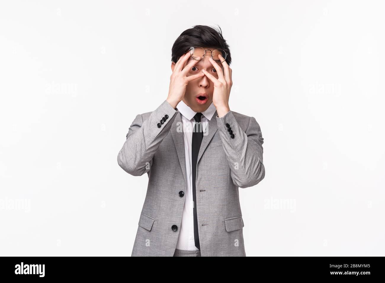 Waist-up portrait of embarrassed and shocked young asian male office ...