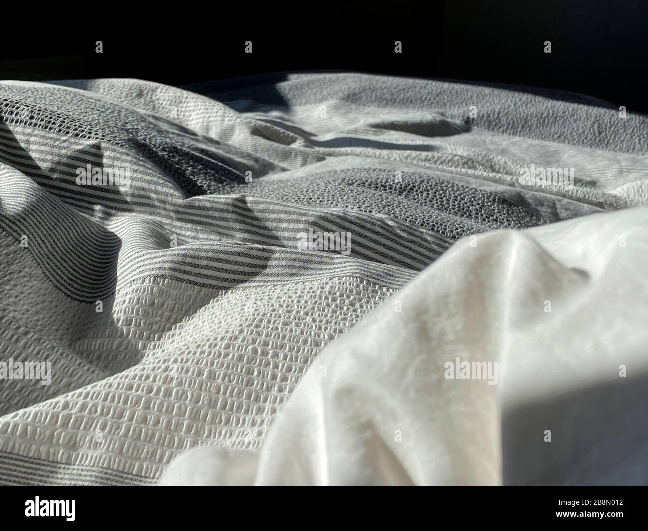 Crumpled bed sheets and quilt cover resemble a snowy landscape Stock ...
