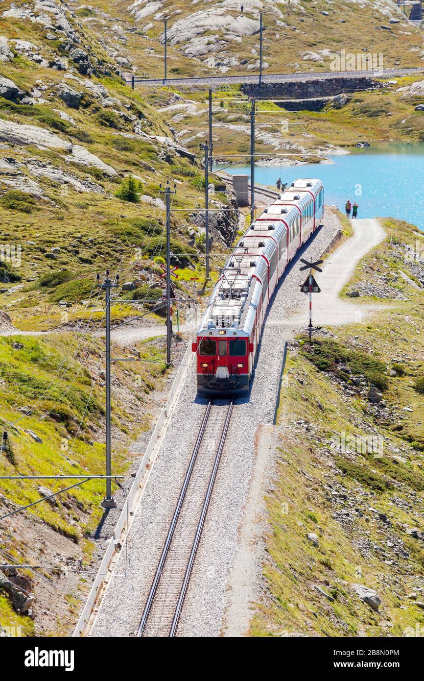 Bernina red train (CH) - In transit on the shore of the White Lake ...