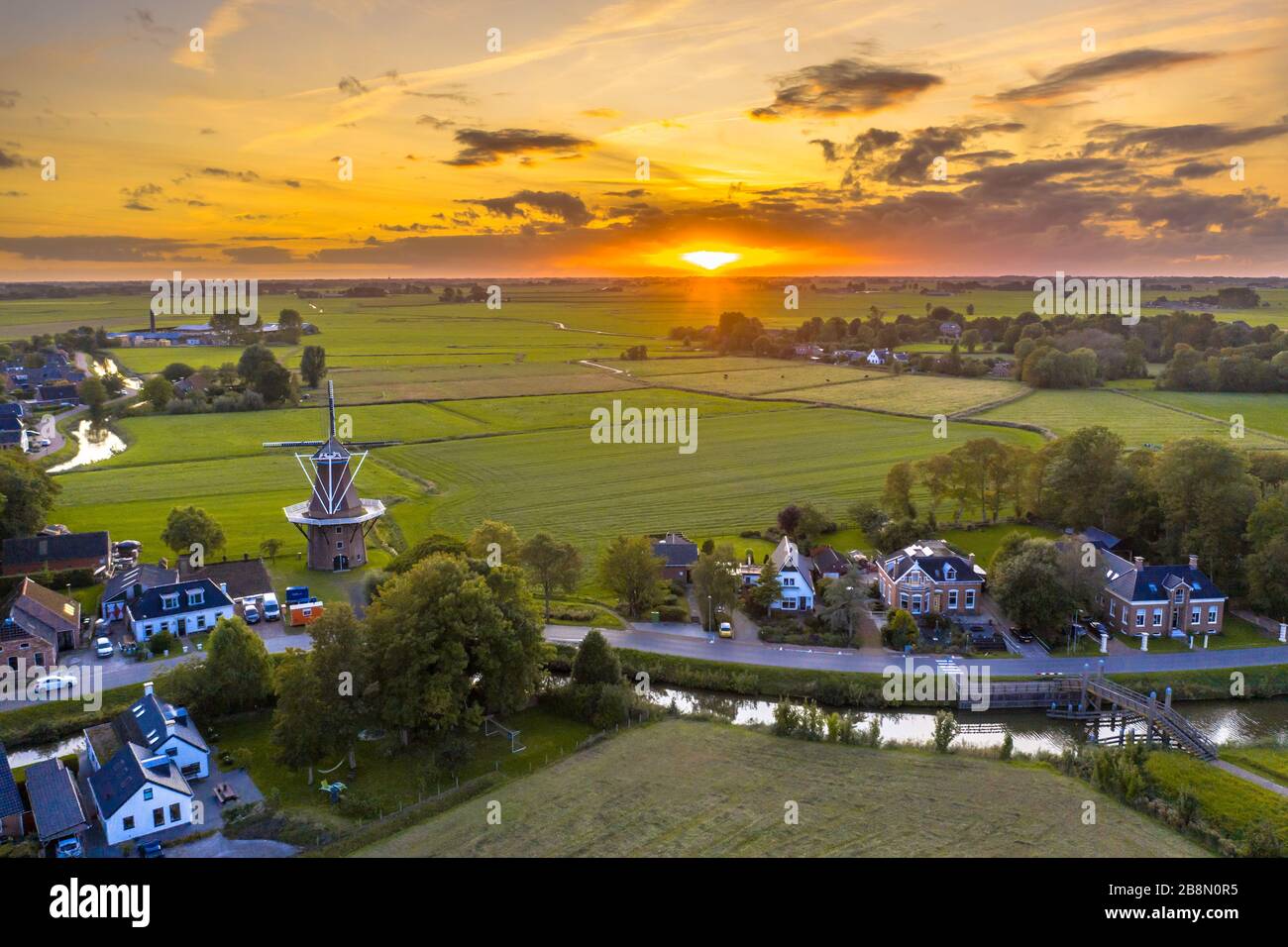 Aerial view of sunset over dutch village in agricultural countryside ...