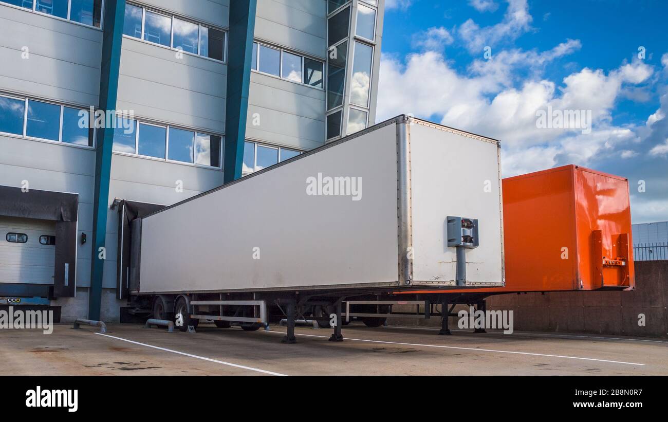 Two truck trailers loading at logistic warehouse distribution centre ...