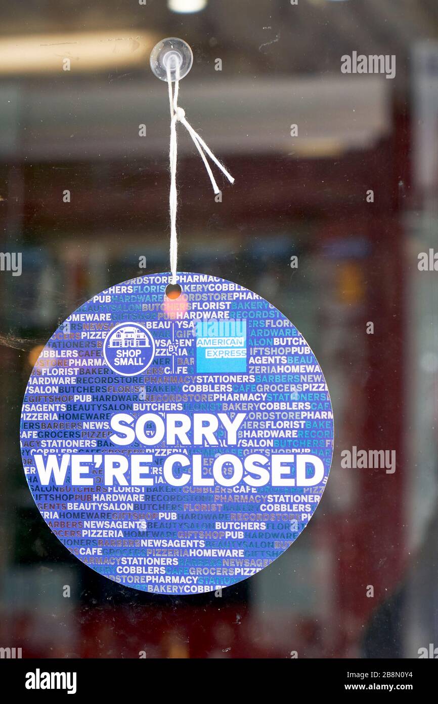 Round sorry we are closed sign hanging in shop door window Stock Photo ...