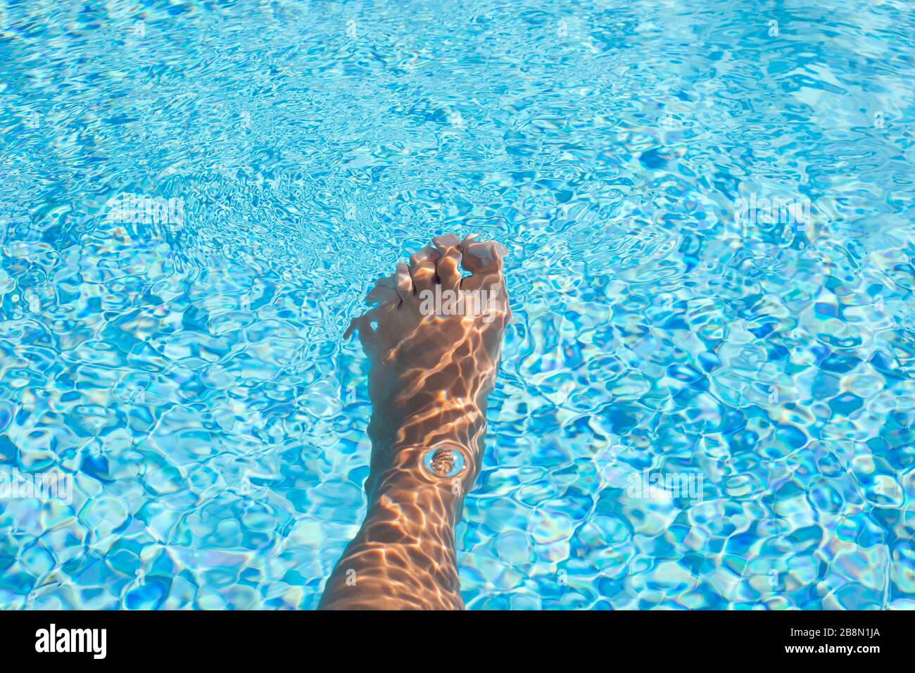 Foot in a swimming pool Stock Photo - Alamy