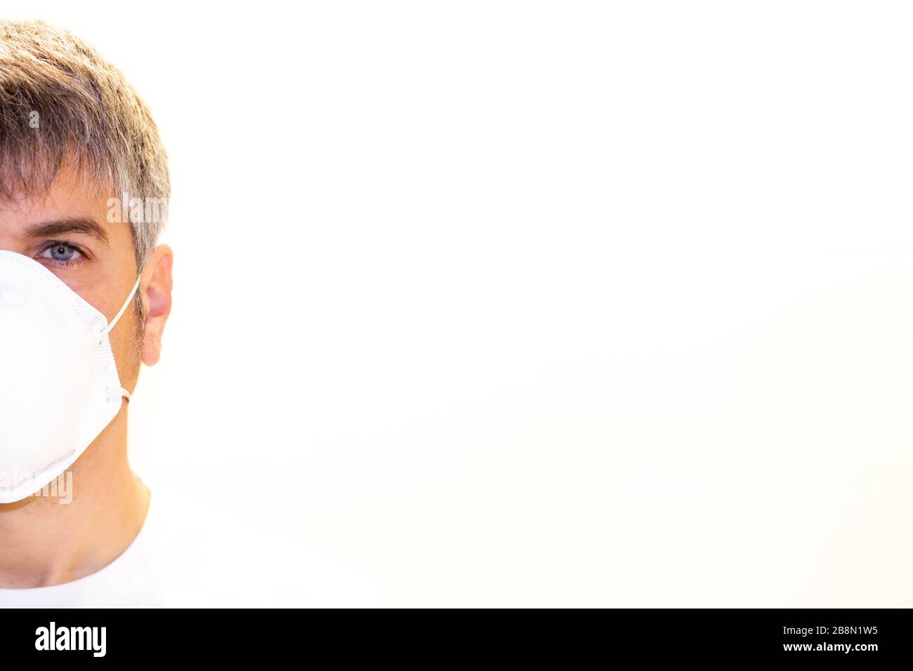 Half-face portrait of a man in a mask on white background. Pandemic ...