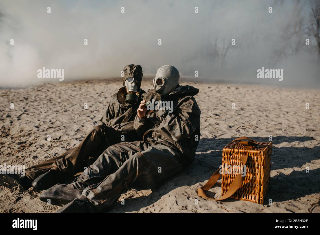 Couple in love sits at outing in NBC protective suits and gas masks on ...