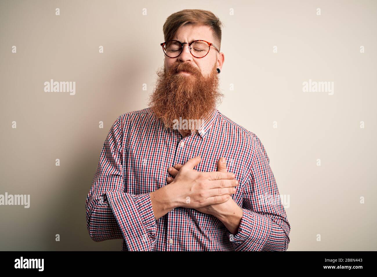 Handsome Irish redhead business man with beard wearing glasses over ...