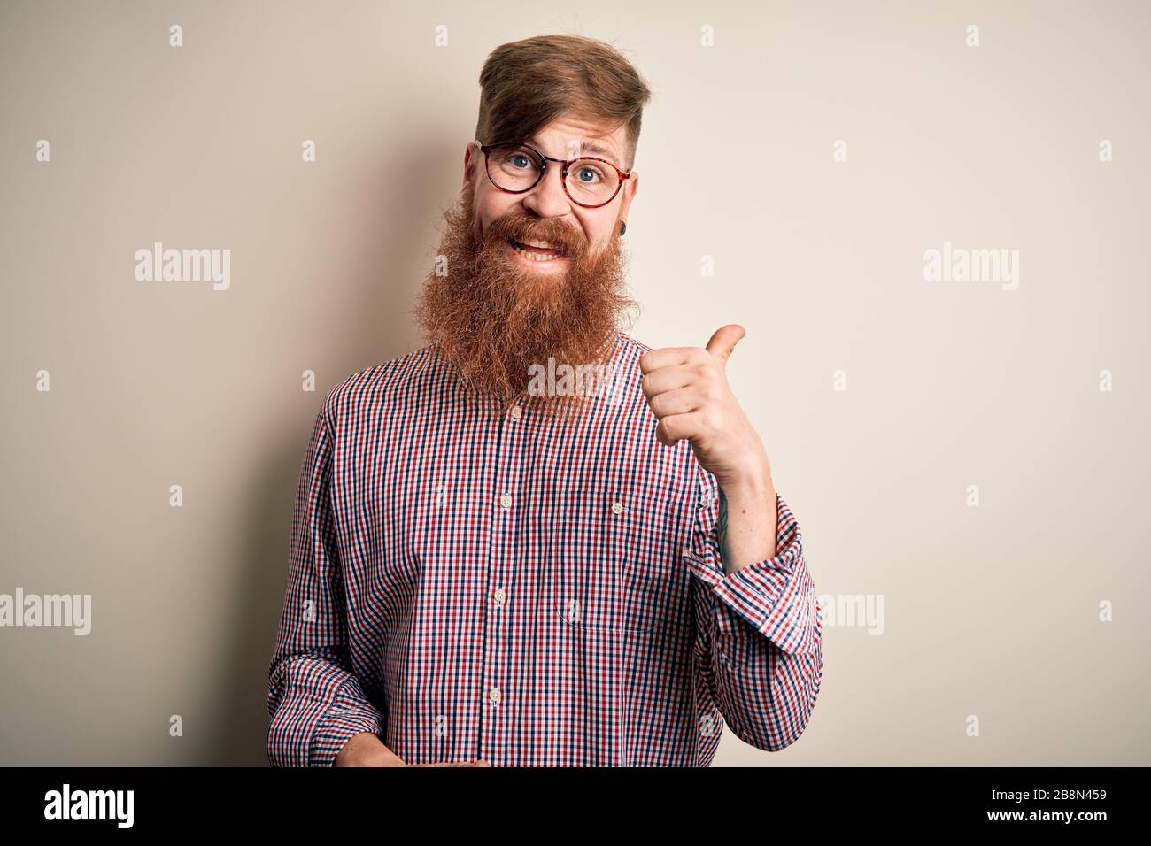 Handsome Irish redhead business man with beard wearing glasses over ...