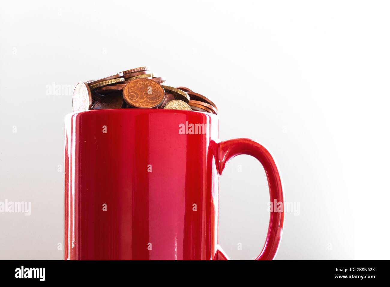 Saved Money in a colorful red mug to Finance Goals overflowing with ...