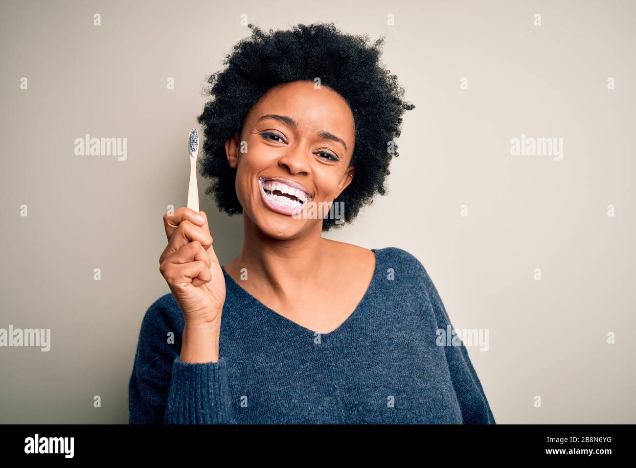 African american woman brushing her teeth using tooth brush and oral ...