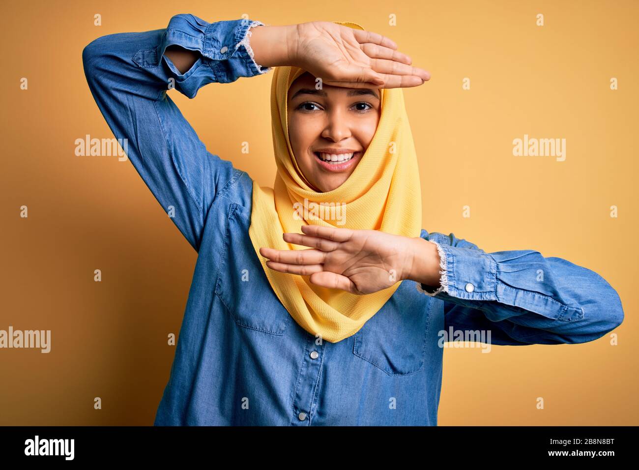 Young beautiful woman with curly hair wearing arab traditional hijab ...