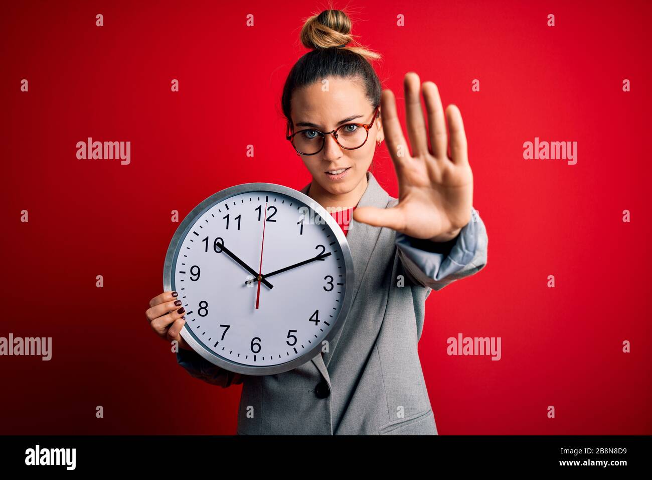 Beautiful blonde woman with blue eyes wearing glasses doing countdown ...