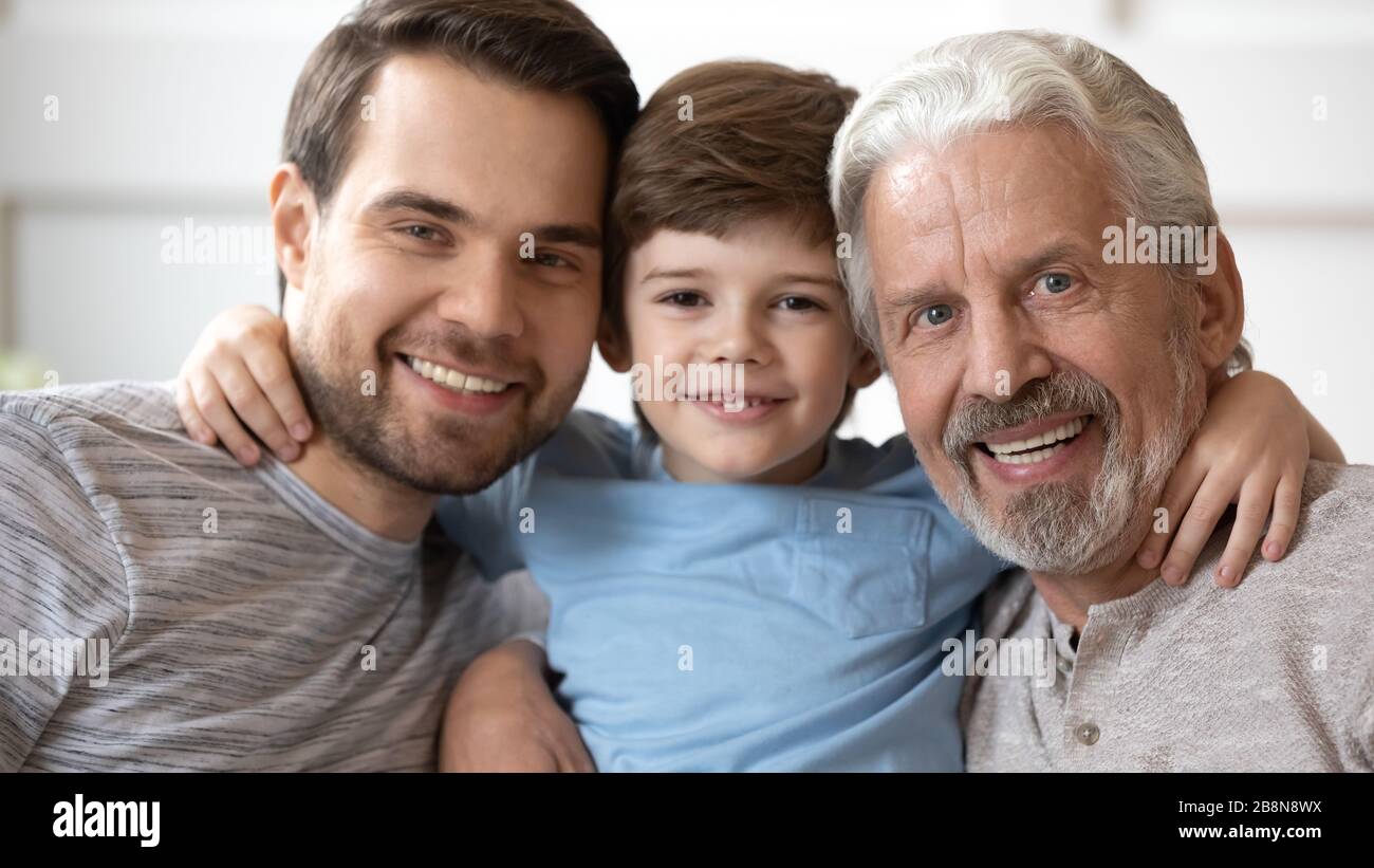 Portrait of happy three generations of men posing at home Stock Photo ...