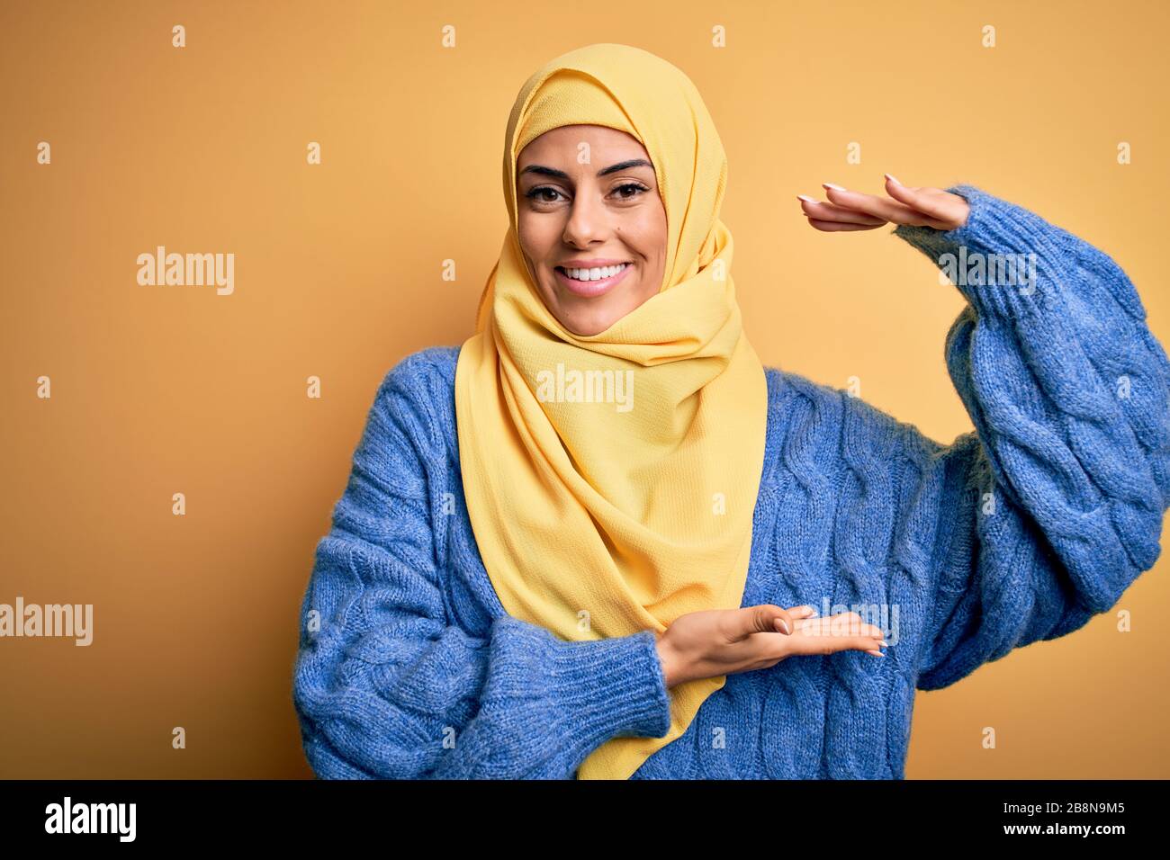 Young beautiful brunette muslim woman wearing arab hijab over isolated ...