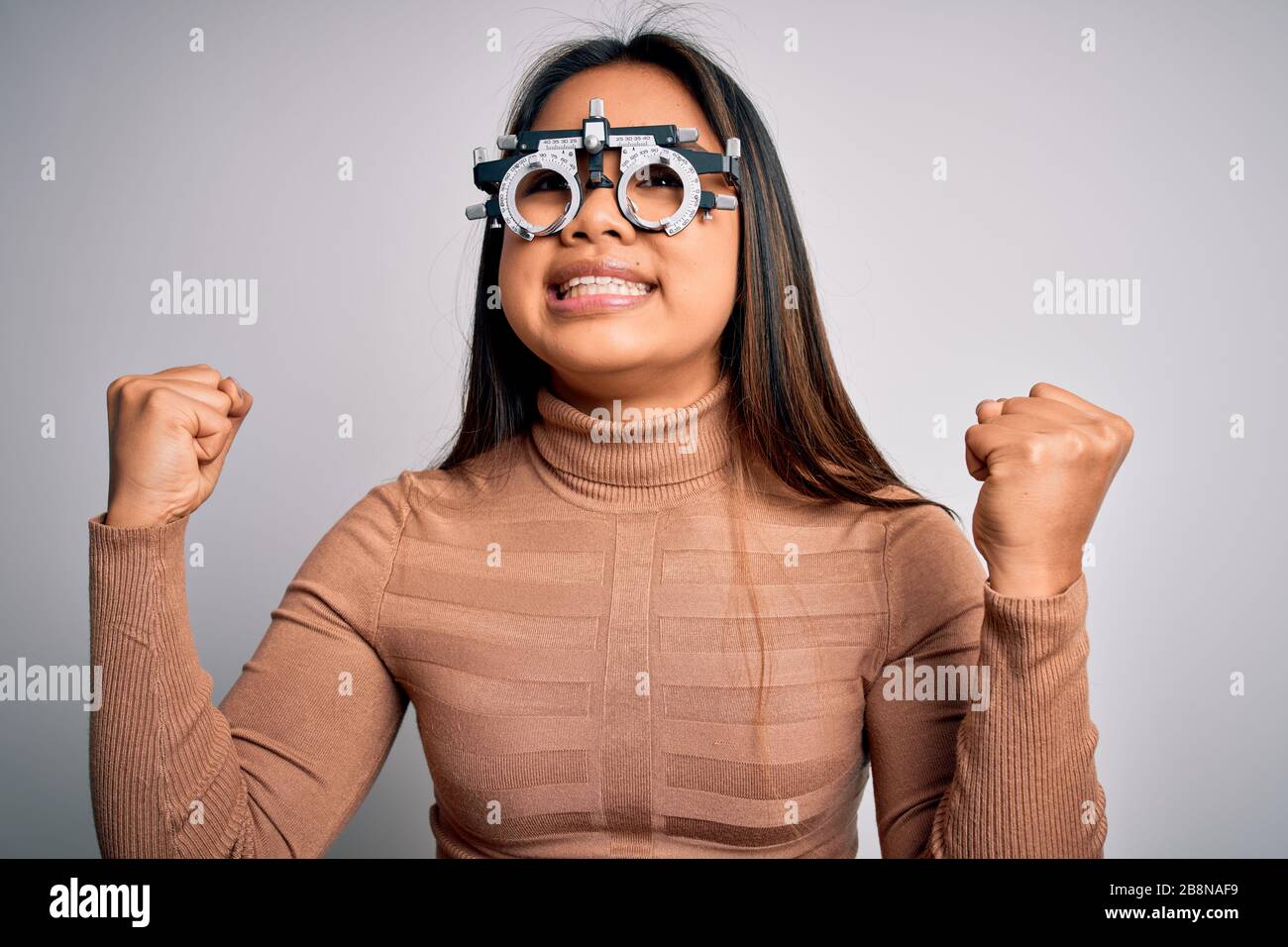 Young asian optical girl controlling eyesight using optometry glasses ...