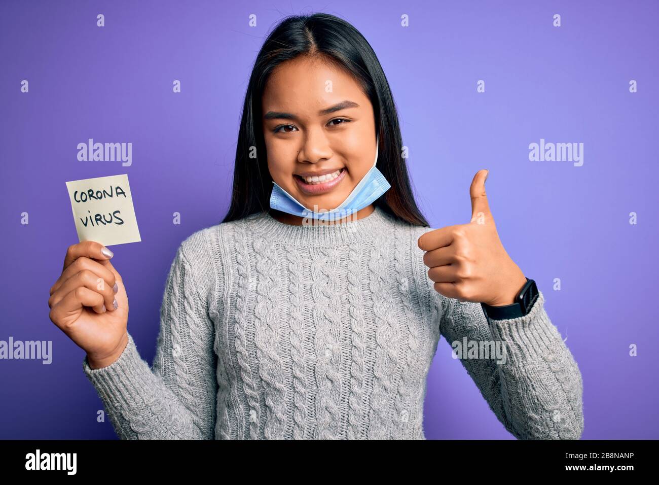 Asian girl wearing medical mask asking for alert holding reminder with ...