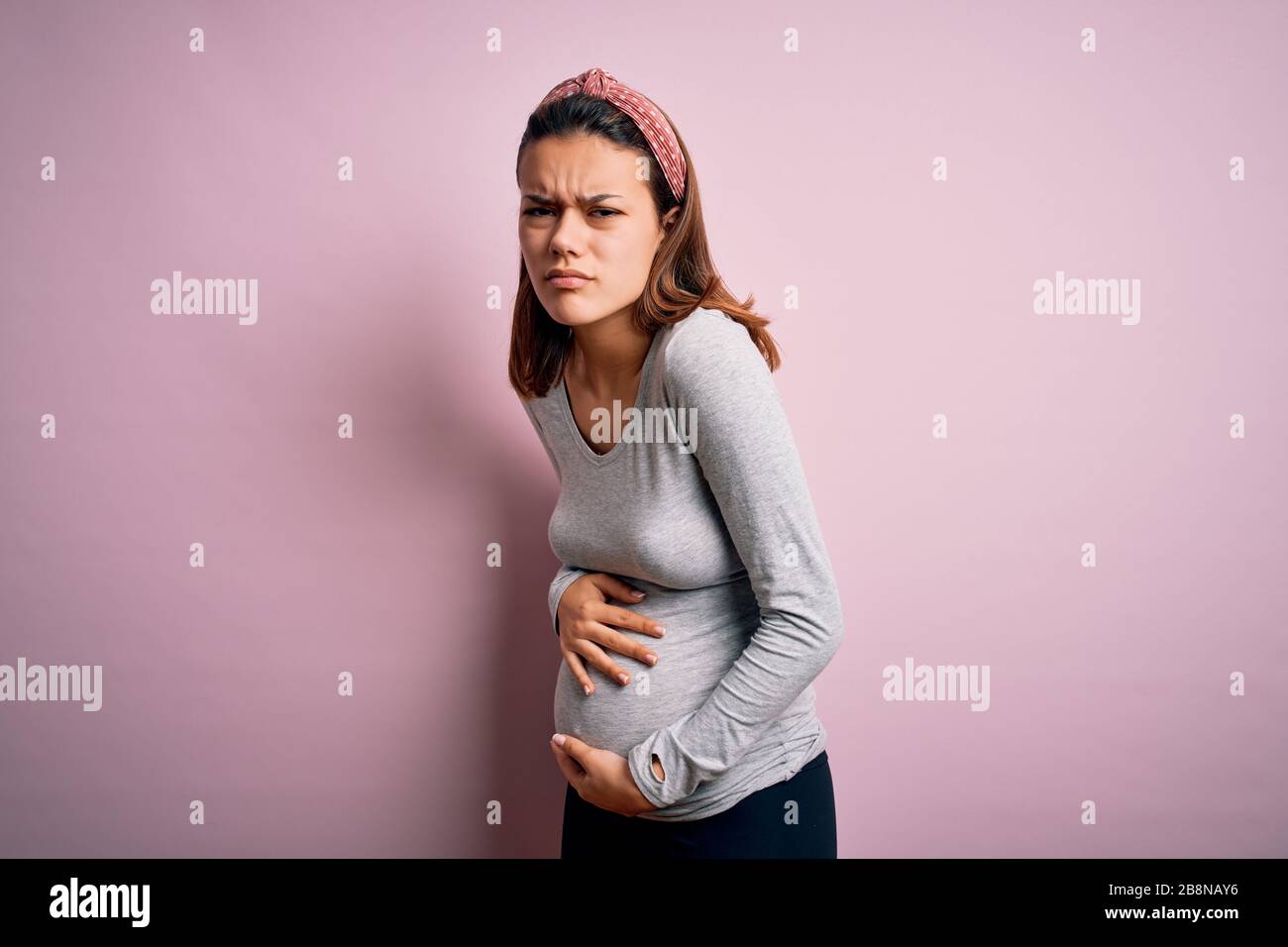 Young beautiful teenager girl pregnant expecting baby over isolated ...