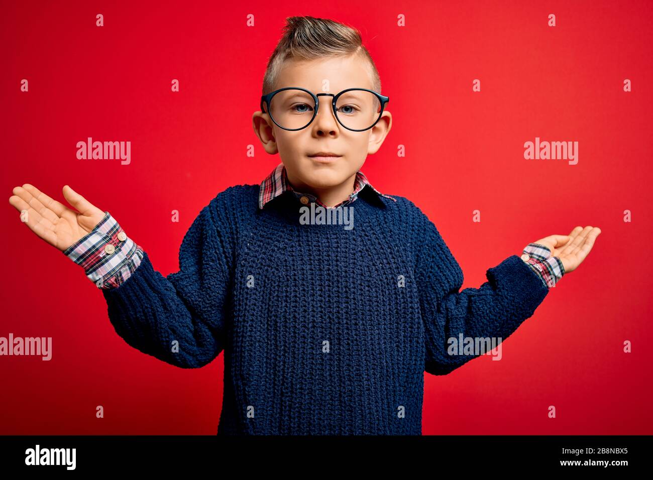 Young little caucasian kid with blue eyes standing wearing smart ...