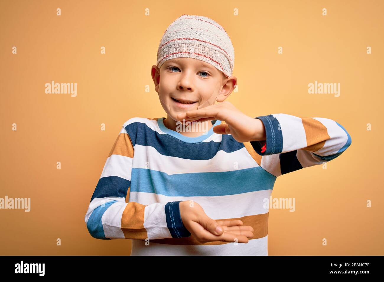 Young little caucasian kid injured wearing medical bandage on head over ...