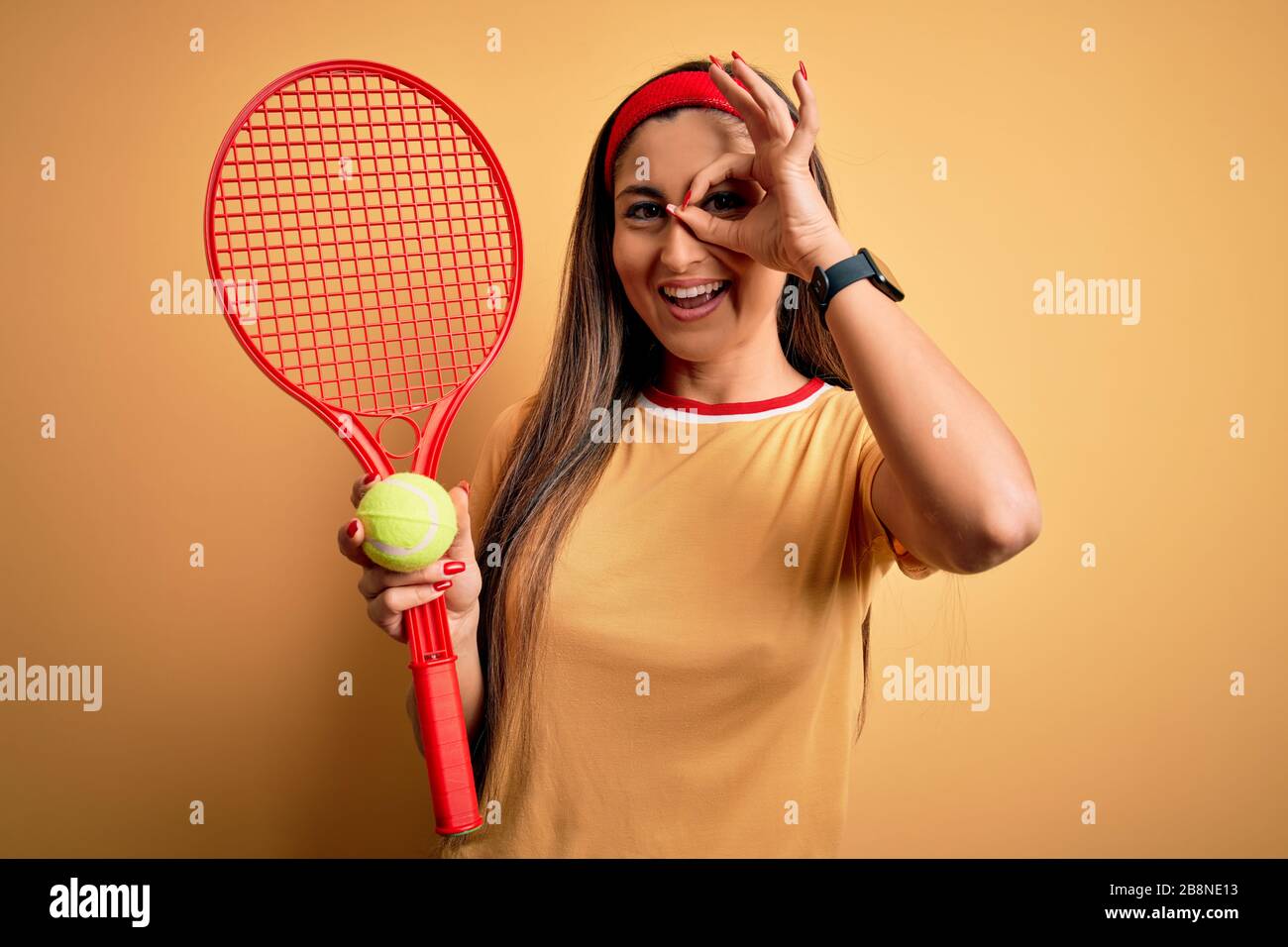 Beautiful brunette sportswoman playing tennis using racket and ball ...