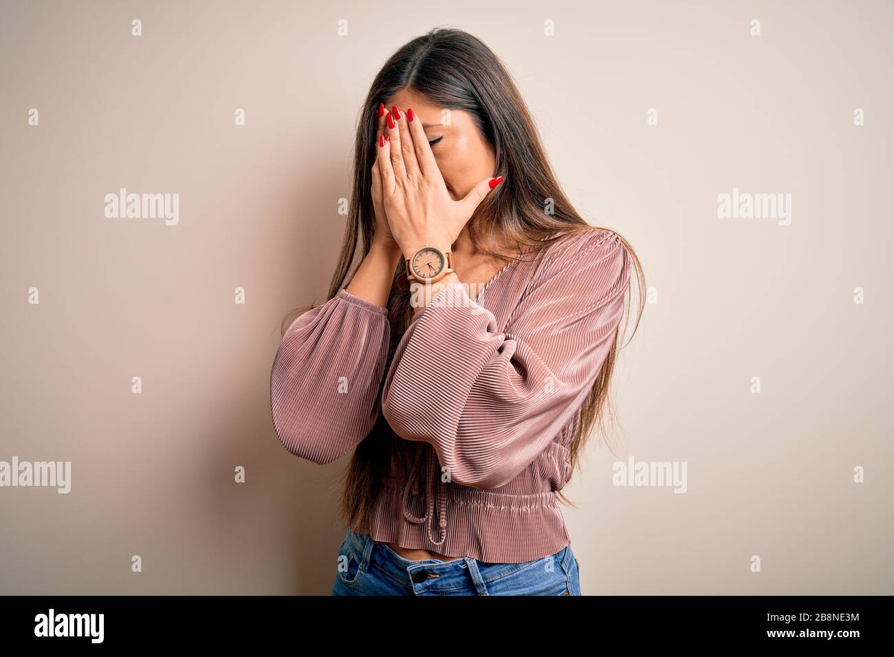 Young beautiful brunette elegant woman with long hair standing over ...