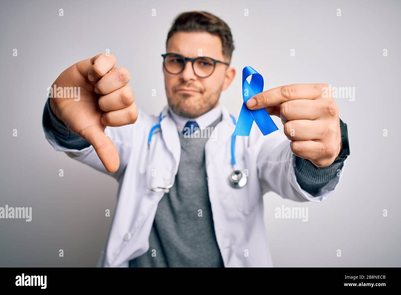 Young doctor man wearing medical coat and holding colon cancer ...