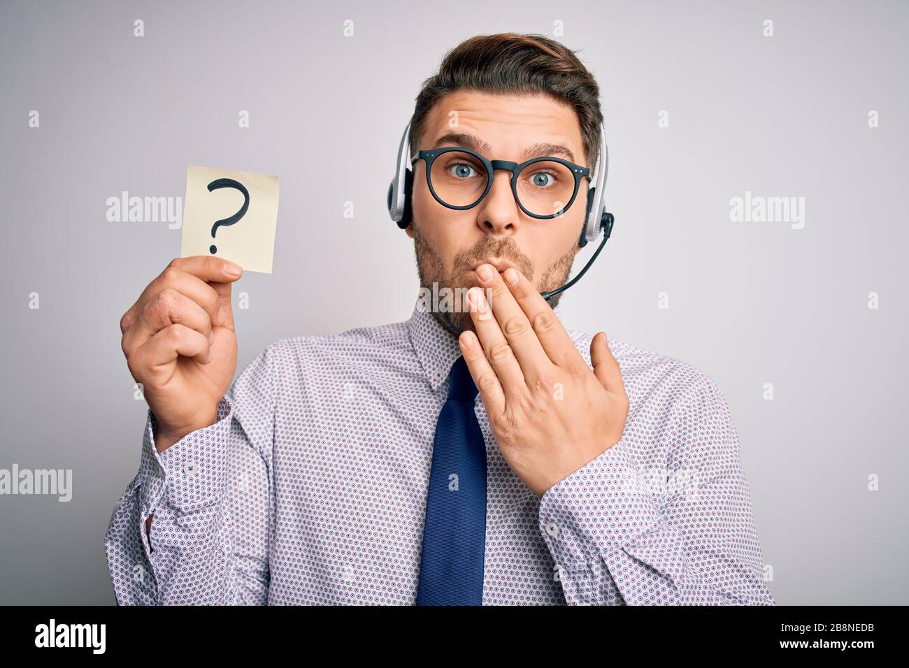 Young call center operator business man with blue eyes holding paper ...