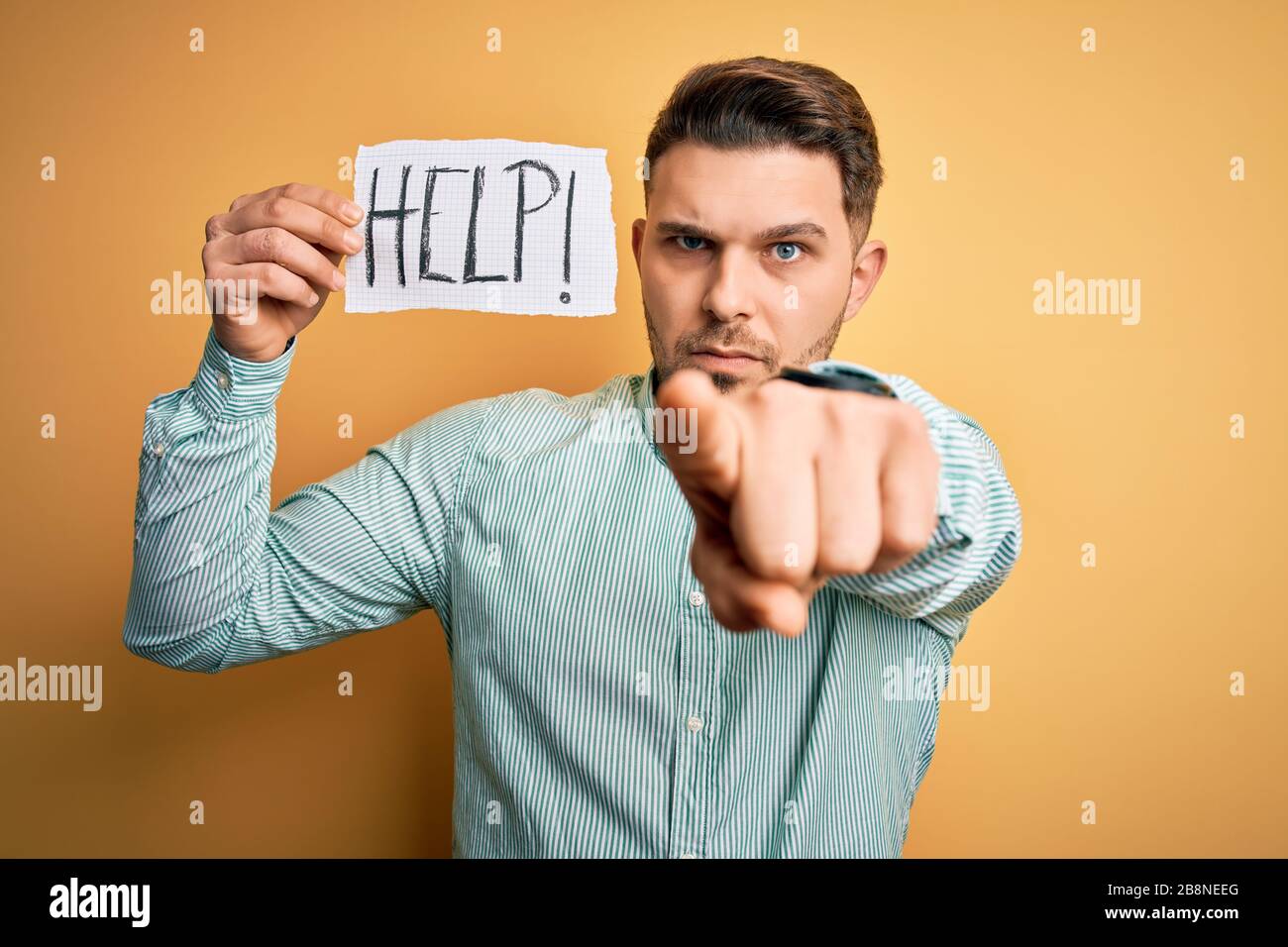 Young business man with blue eyes asking for help holding paper note ...