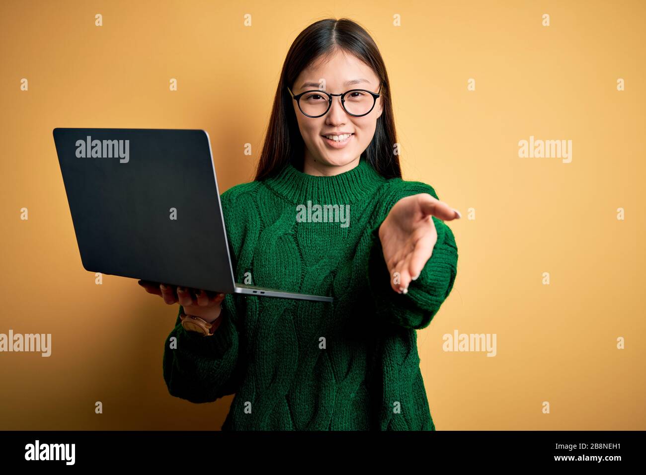 Young asian business woman wearing glasses and working using computer ...