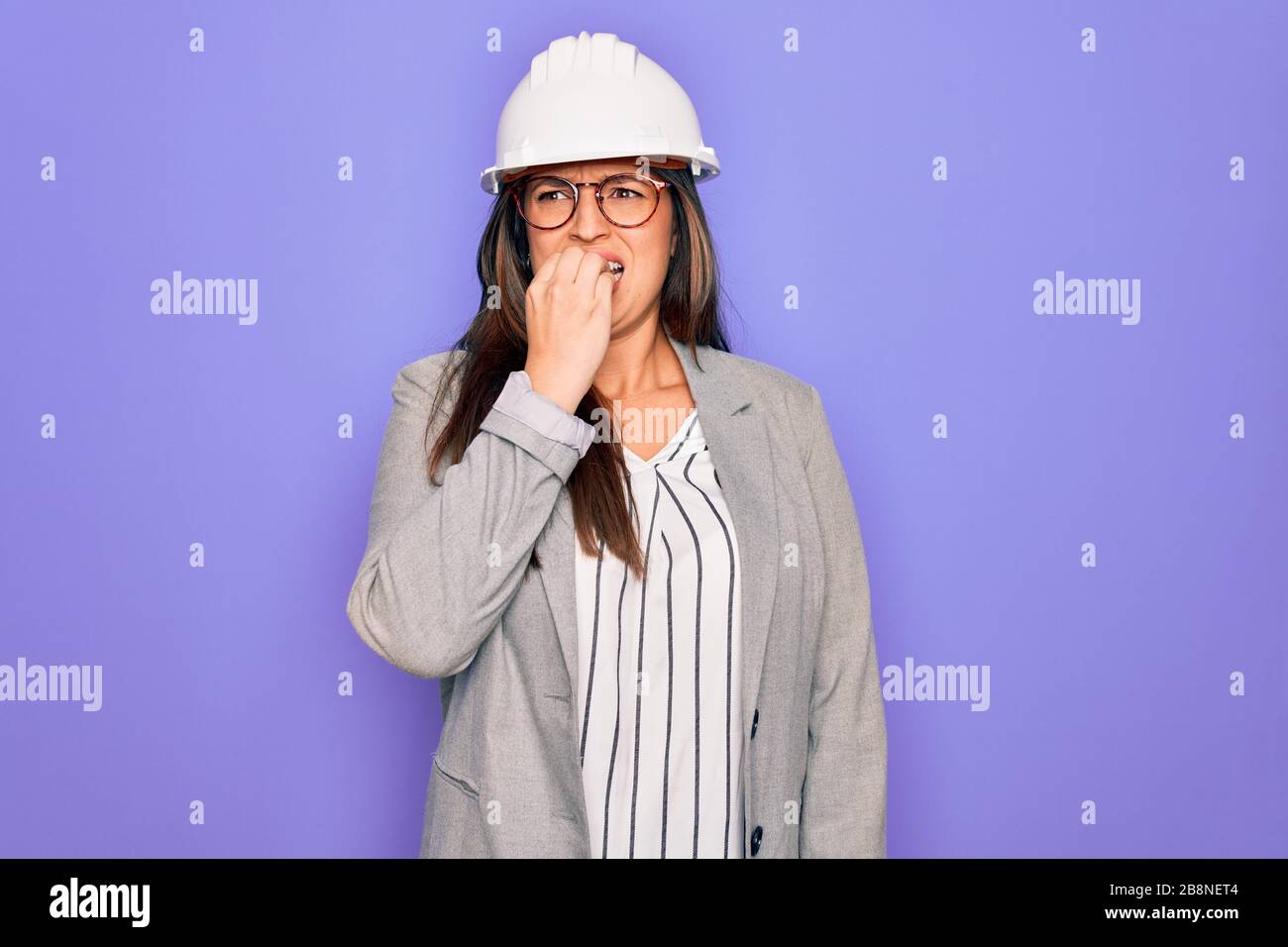 Professional woman engineer wearing industrial safety helmet over ...