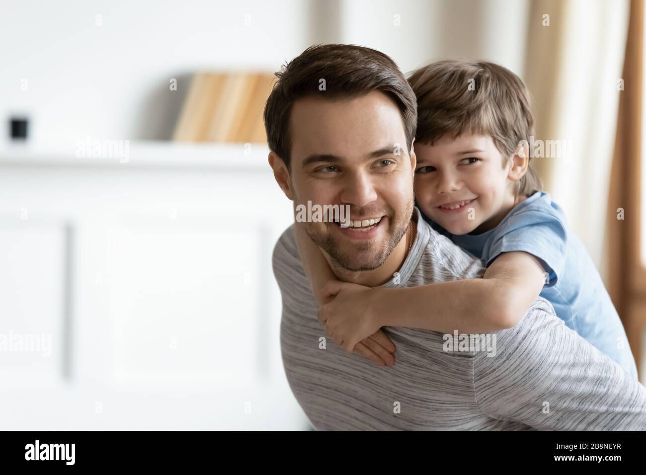 Overjoyed little boy piggyback play with young dad Stock Photo - Alamy