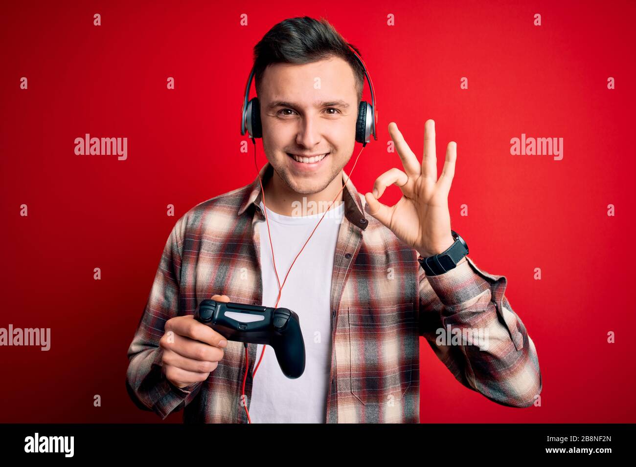 Young handsome caucasian gamer man playing video games using console ...