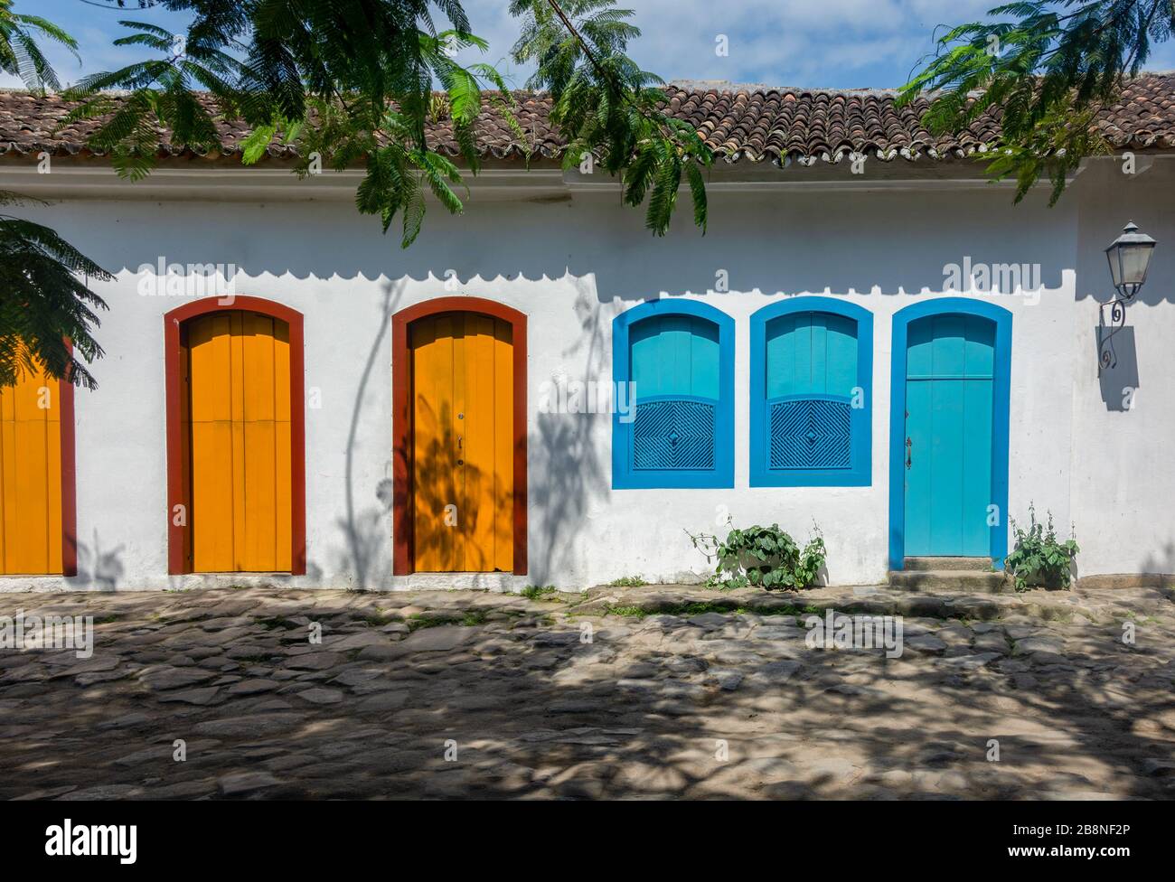 Facade of typical colorful house with cobbled street in Paraty, Rio de ...