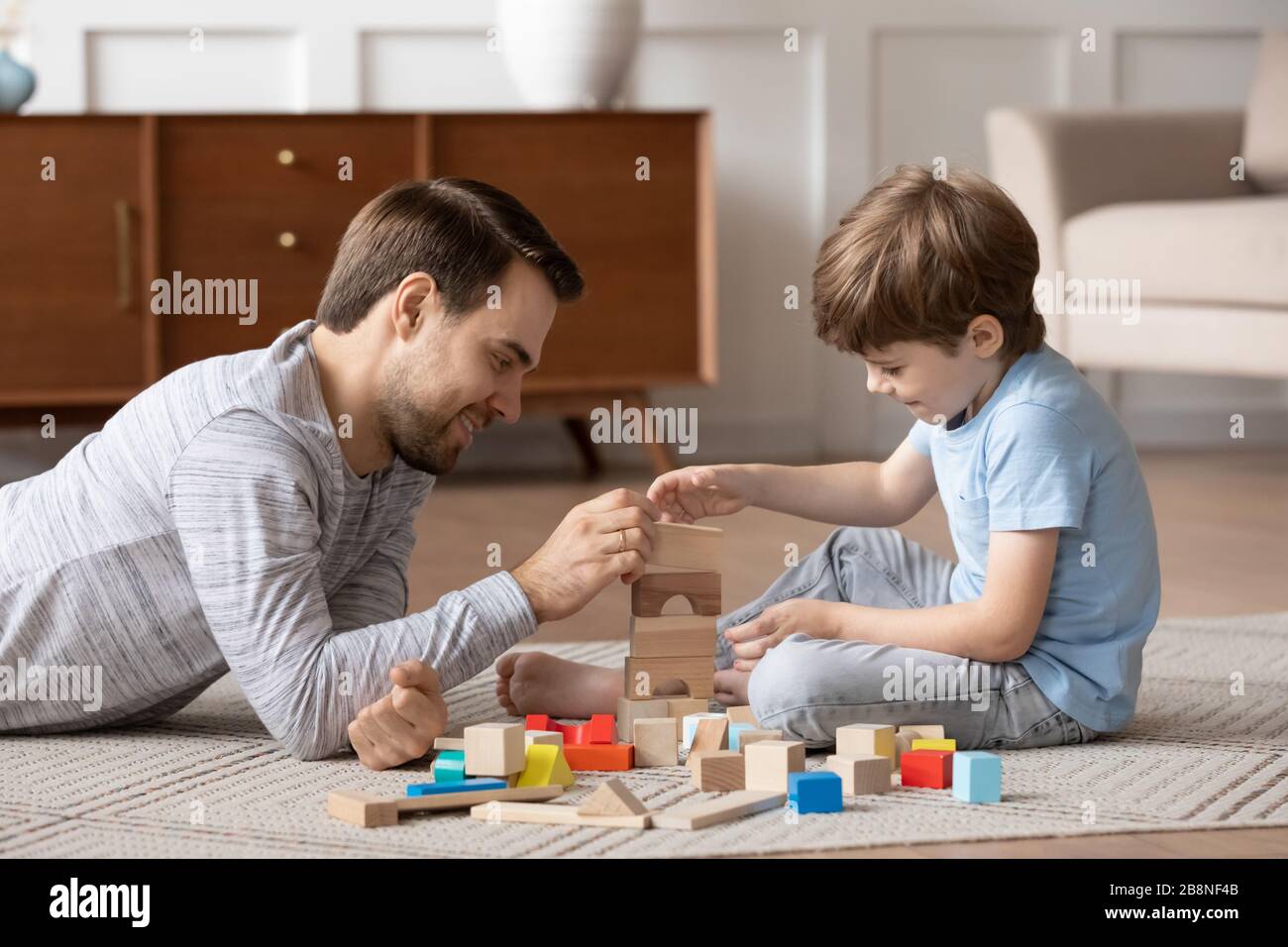 Young dad play with building bricks with small son Stock Photo - Alamy