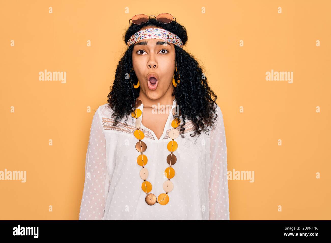 Young african american curly hippie woman wearing sunglasses and ...