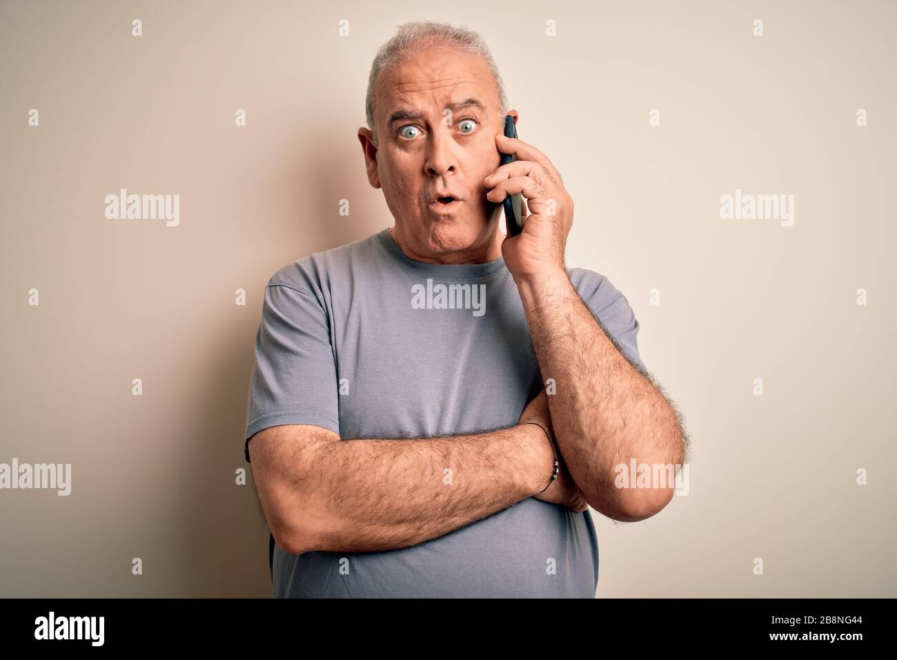 Middle age hoary man having conversation talking on the smartphone over ...