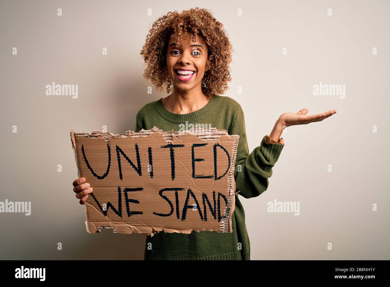 African american activist woman asking for unity holding banner with ...