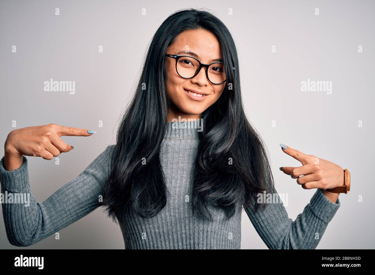 Young beautiful chinese woman wearing glasses and sweater over isolated ...