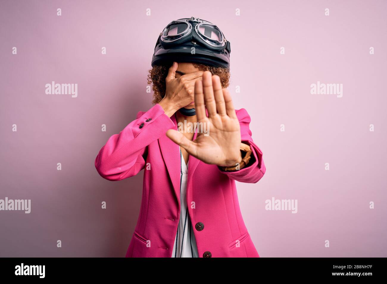 African american motorcyclist woman with curly hair wearing moto helmet ...