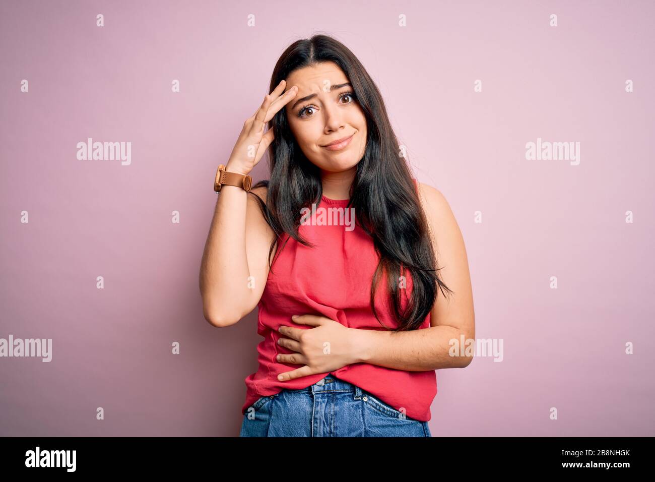 Young brunette woman wearing casual summer shirt over pink isolated ...
