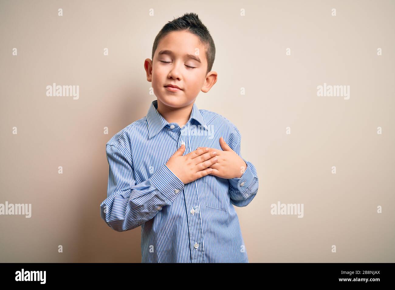 Young little boy kid wearing elegant shirt standing over isolated ...