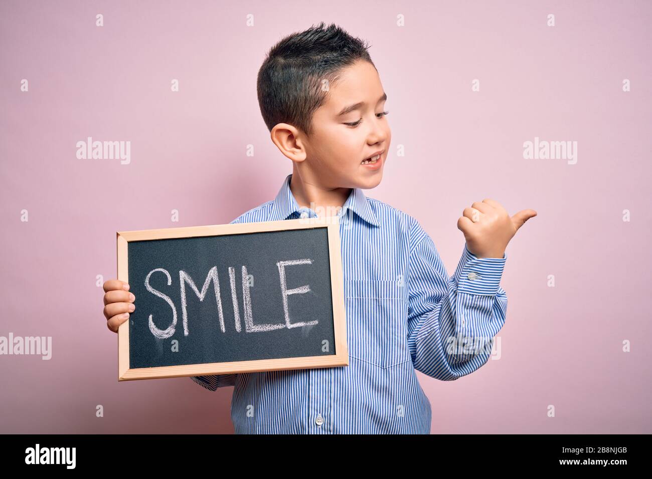 Young little boy kid showing blackboard with smile word as happy ...