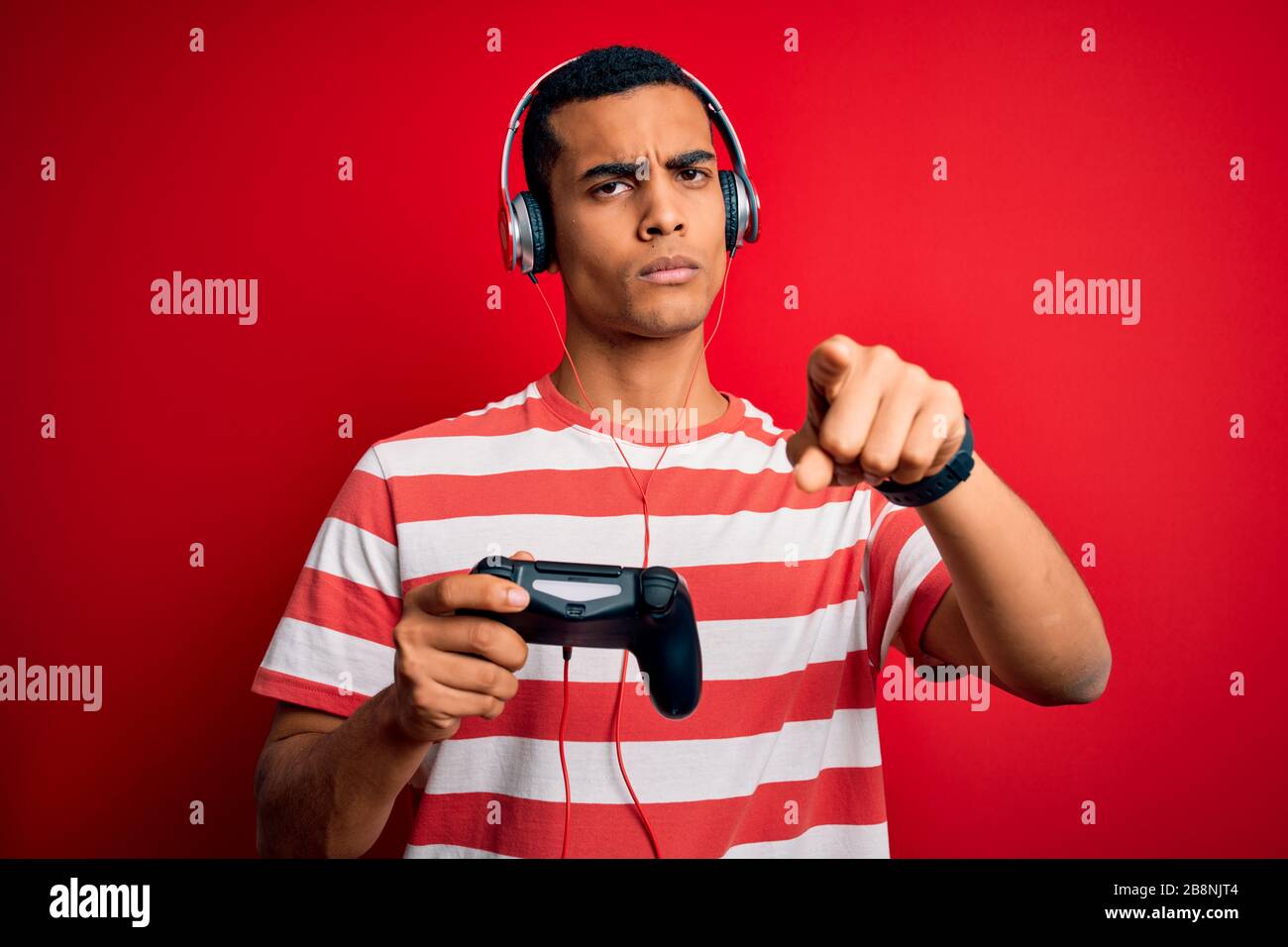 Handsome african american gamer man playing video game using jostick ...